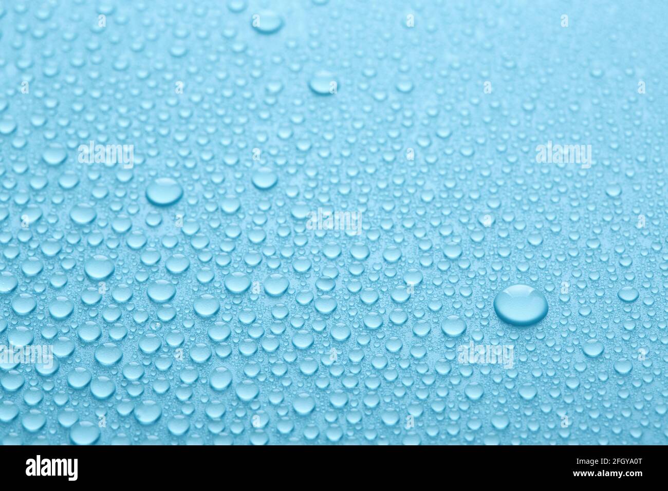Pure water drops on blue abstract background or texture Stock Photo - Alamy