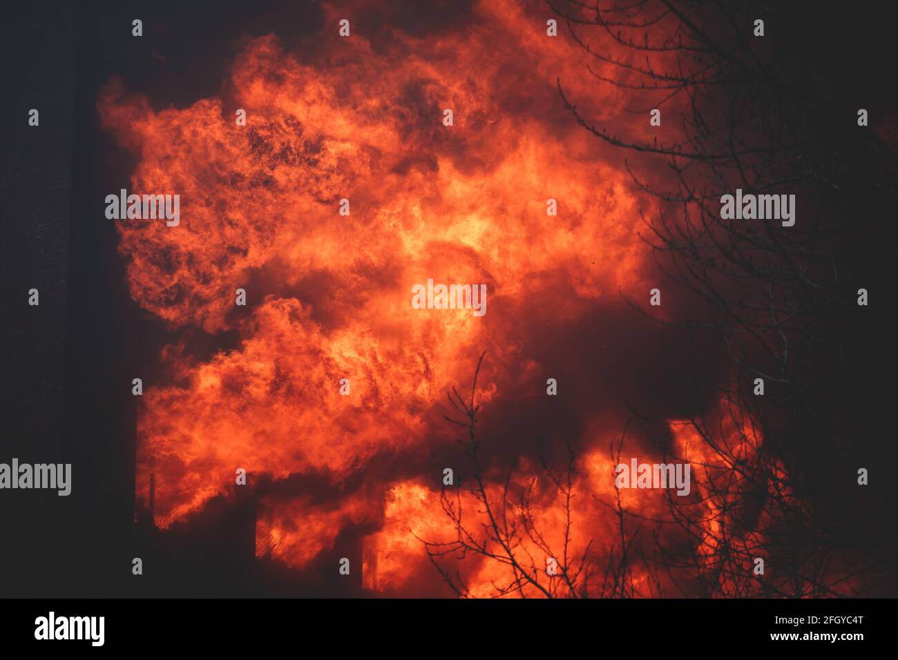 Massive large blaze fire in the city, brick factory building on fire ...