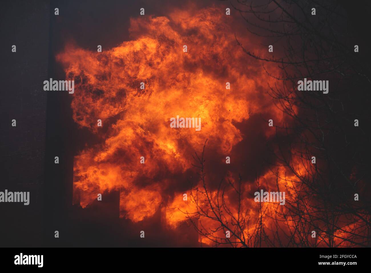 Massive large blaze fire in the city, brick factory building on fire ...