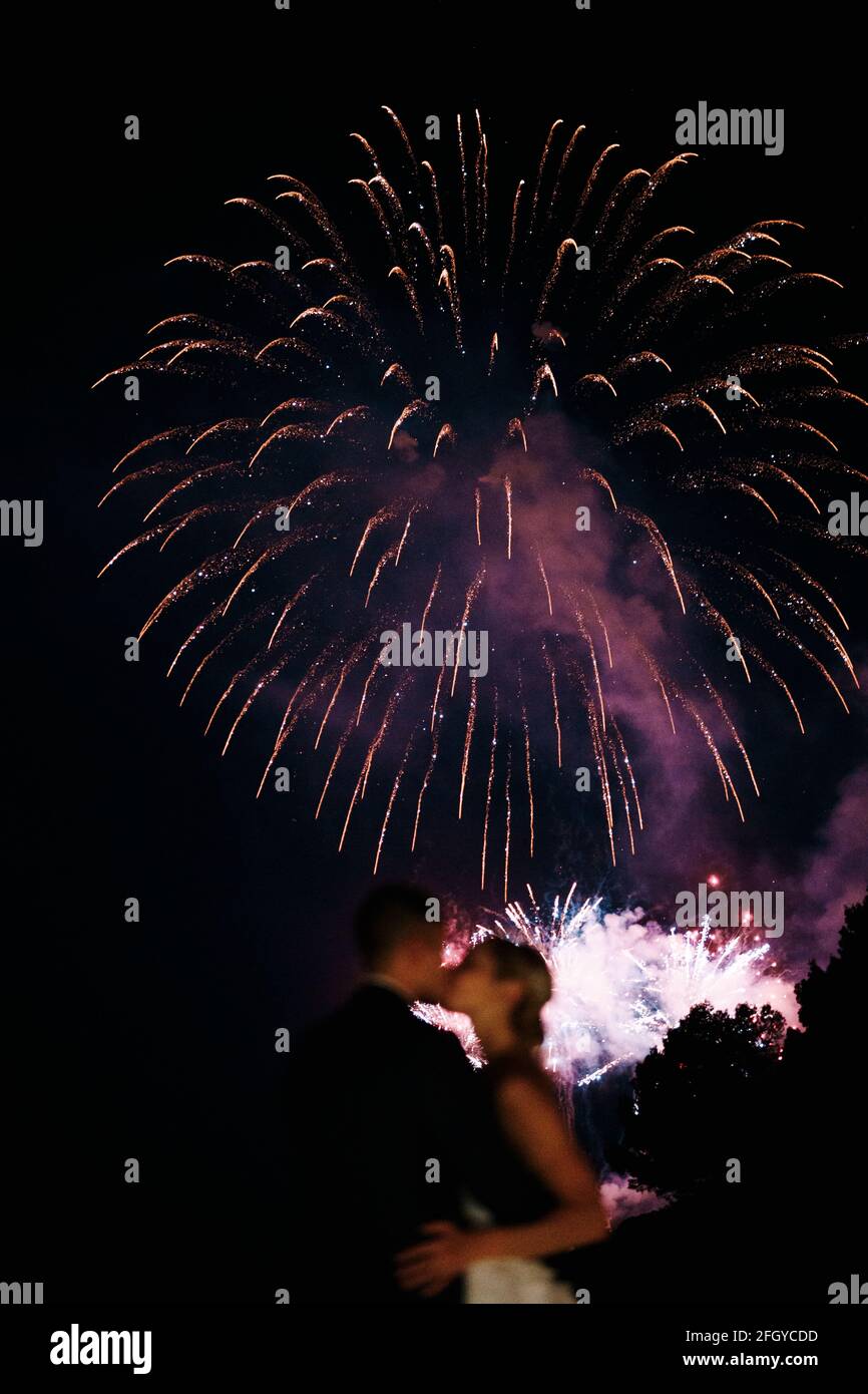 Kissing couple on the background of fireworks in the night sky Stock ...