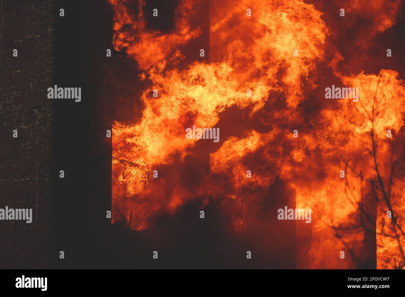 Massive large blaze fire in the city, brick factory building on fire ...