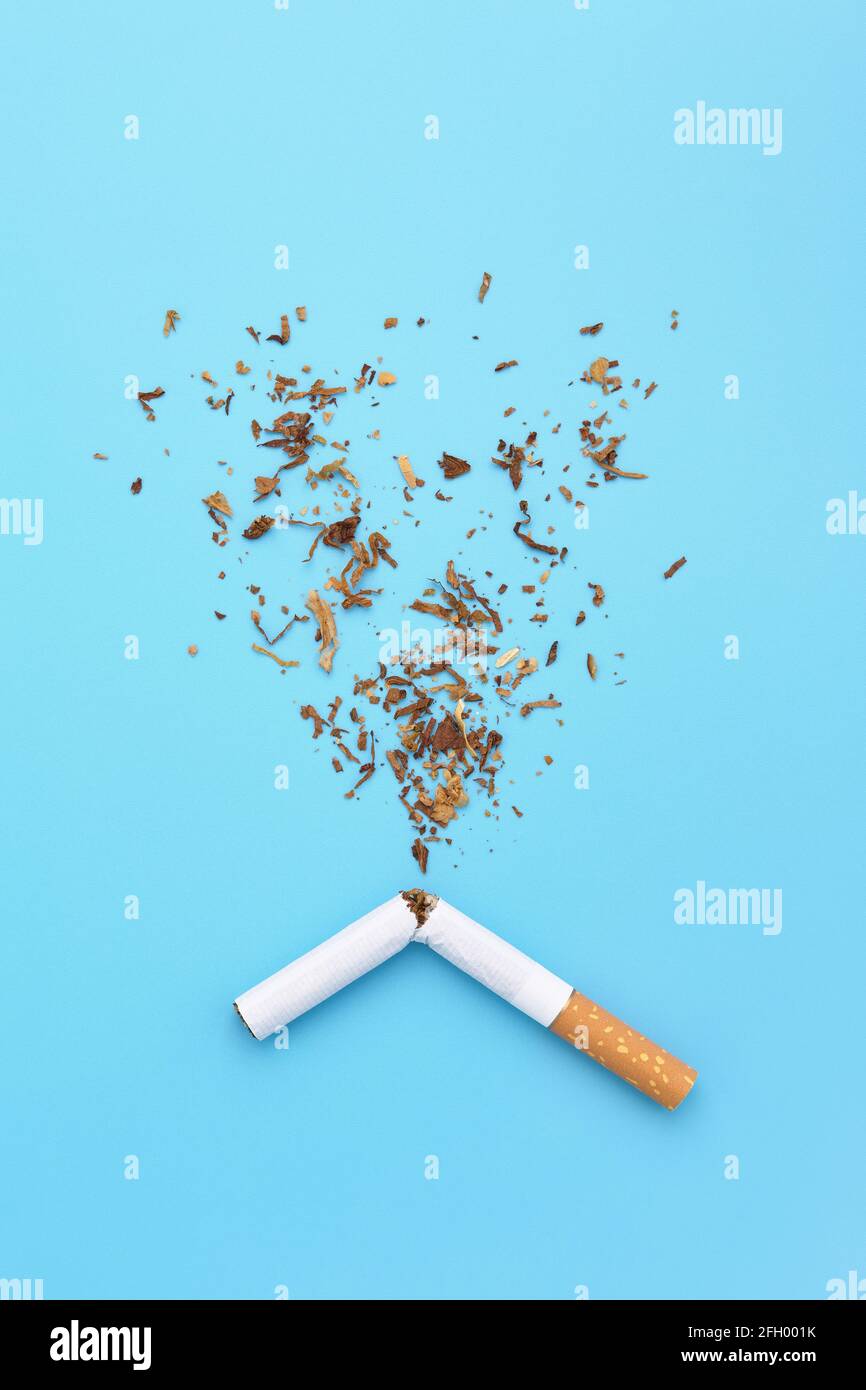 A broken cigarette and tobacco splash for quit smoking concept Stock ...