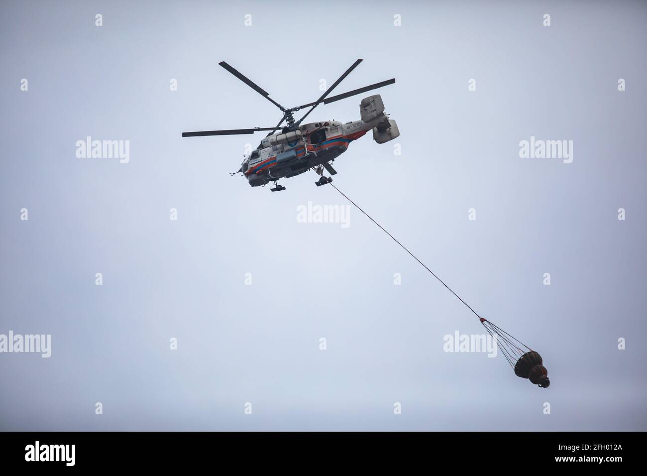 Fire fighting helicopter silhouette with bambi bucket for сarrying ...