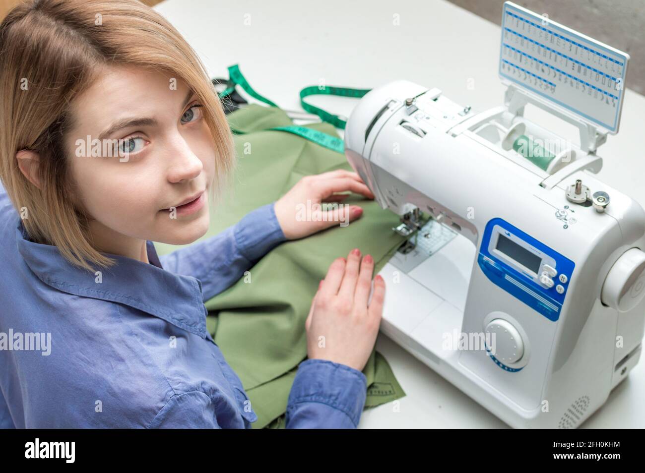 Seamstress sews clothes on a sewing machine. Close-up. Concept sewing ...