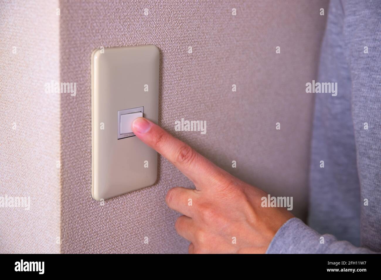 Light switch pushing by male hand daytime closeup Stock Photo - Alamy