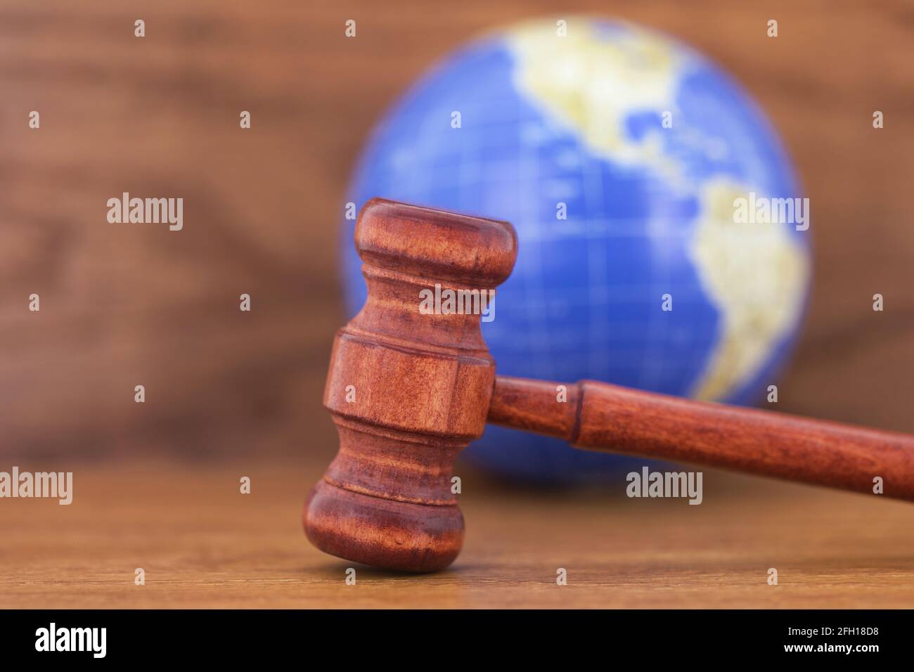 Concept of world justice seen in red wood gavel and globe, symbols of ...