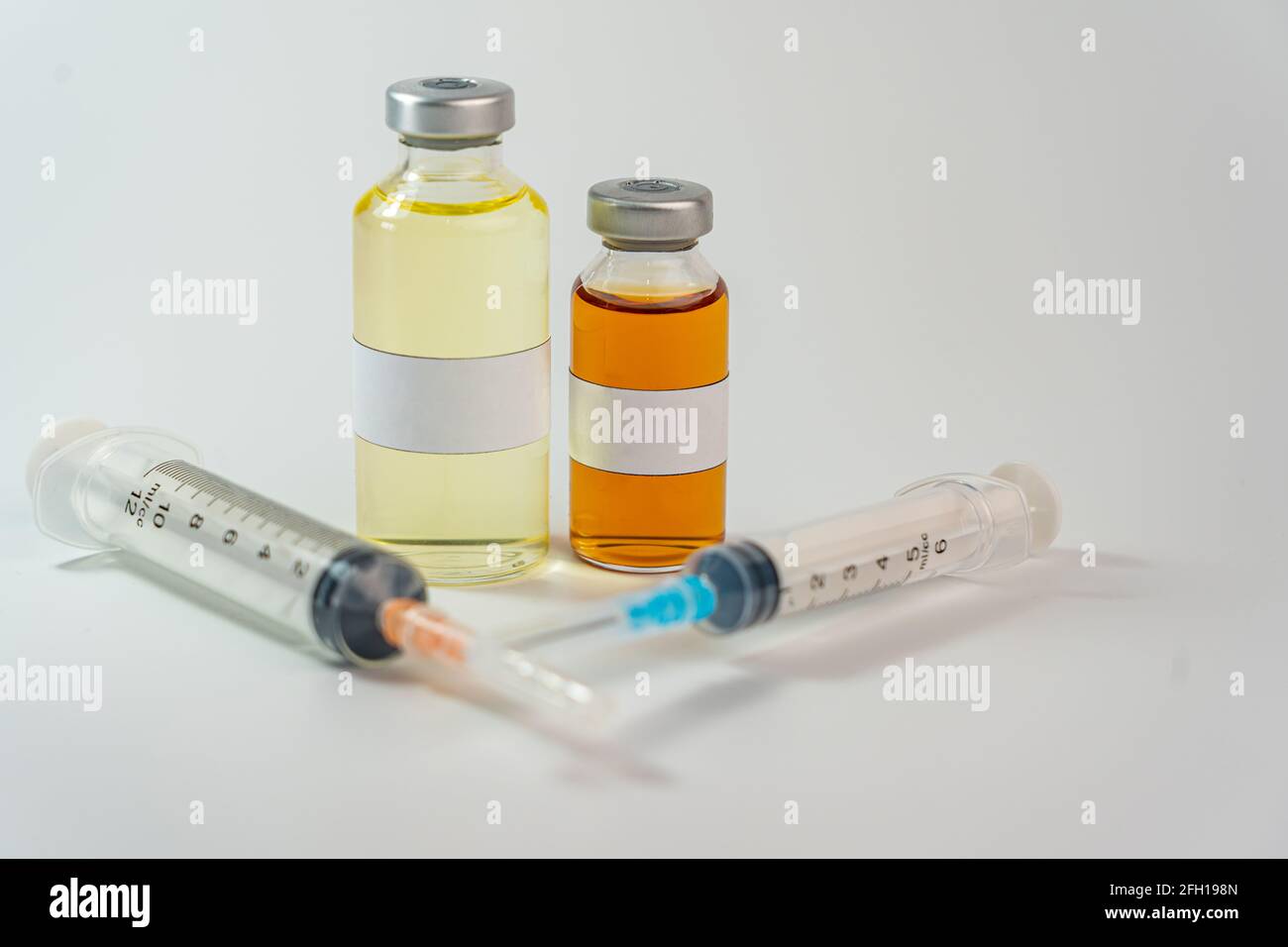 Vaccine bottles with white blank label and syringe injection Stock ...