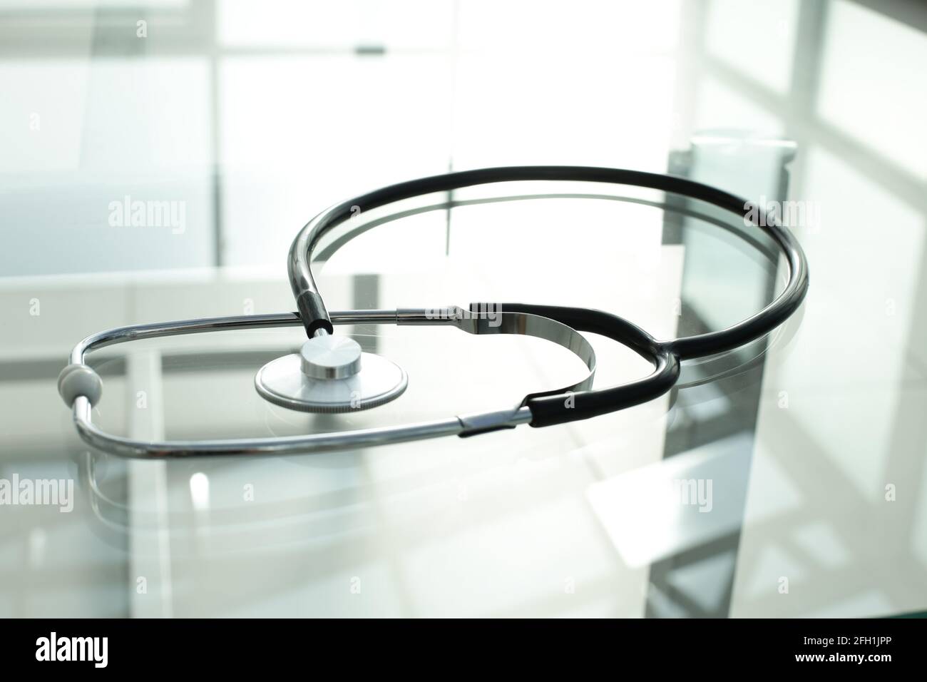 Medical stethoscope on glass table. Close-up Stock Photo - Alamy
