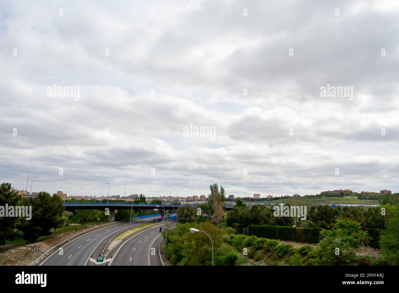 Madrid landscape on a cloudy day with one of the Spanish roads, in ...