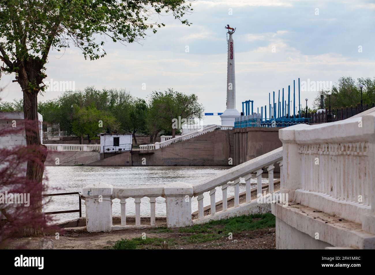 Shardara river dam.Memory stele with jumping snow leopard and numbers ...