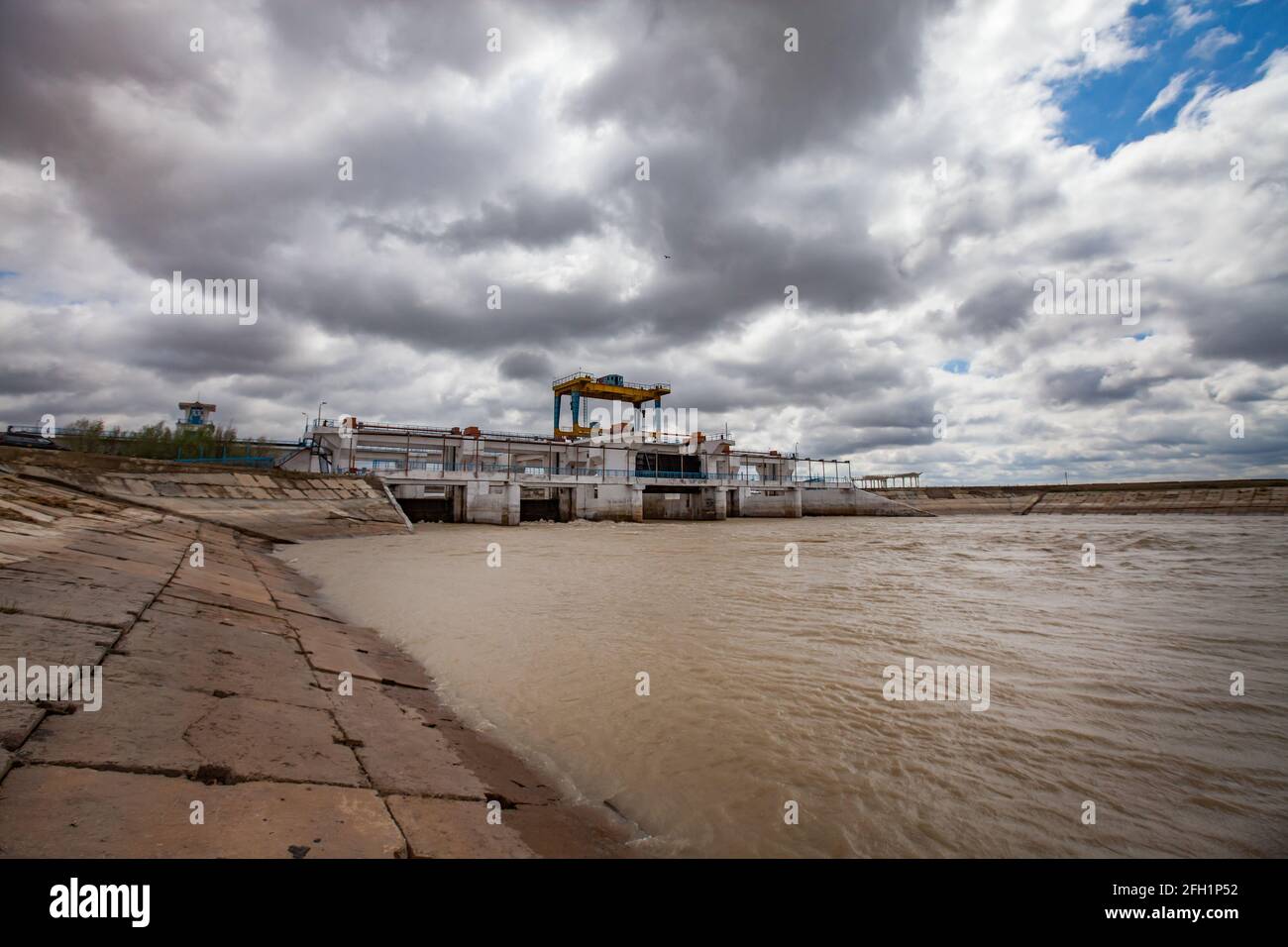 Shardara river dam near Kazaly city. Concrete shore slab. Gantry crane ...
