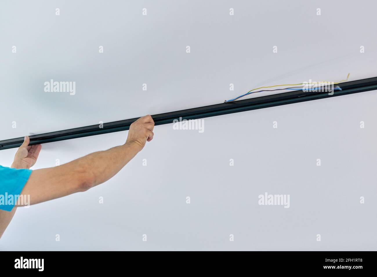 Installation of LED ceiling mounted modern track downlight Stock Photo ...