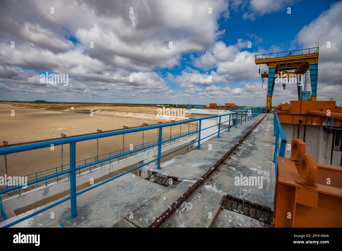 Shardara river dam. Concrete bridge, Gentry crane. blue sky with clouds ...