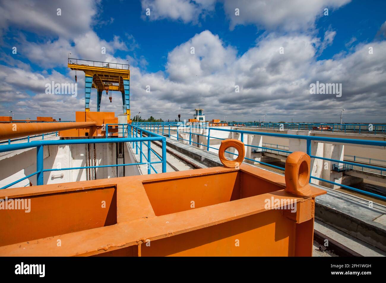 Shardara river dam. Concrete bridge, gentry crane. Orange weights in ...