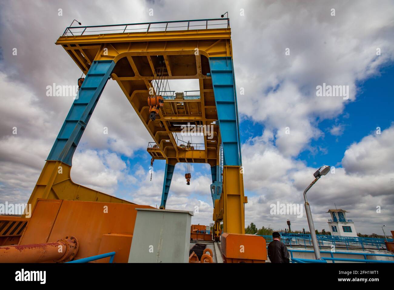 Overhead crane for water shutter lifting on Shardara river dam. Blue ...