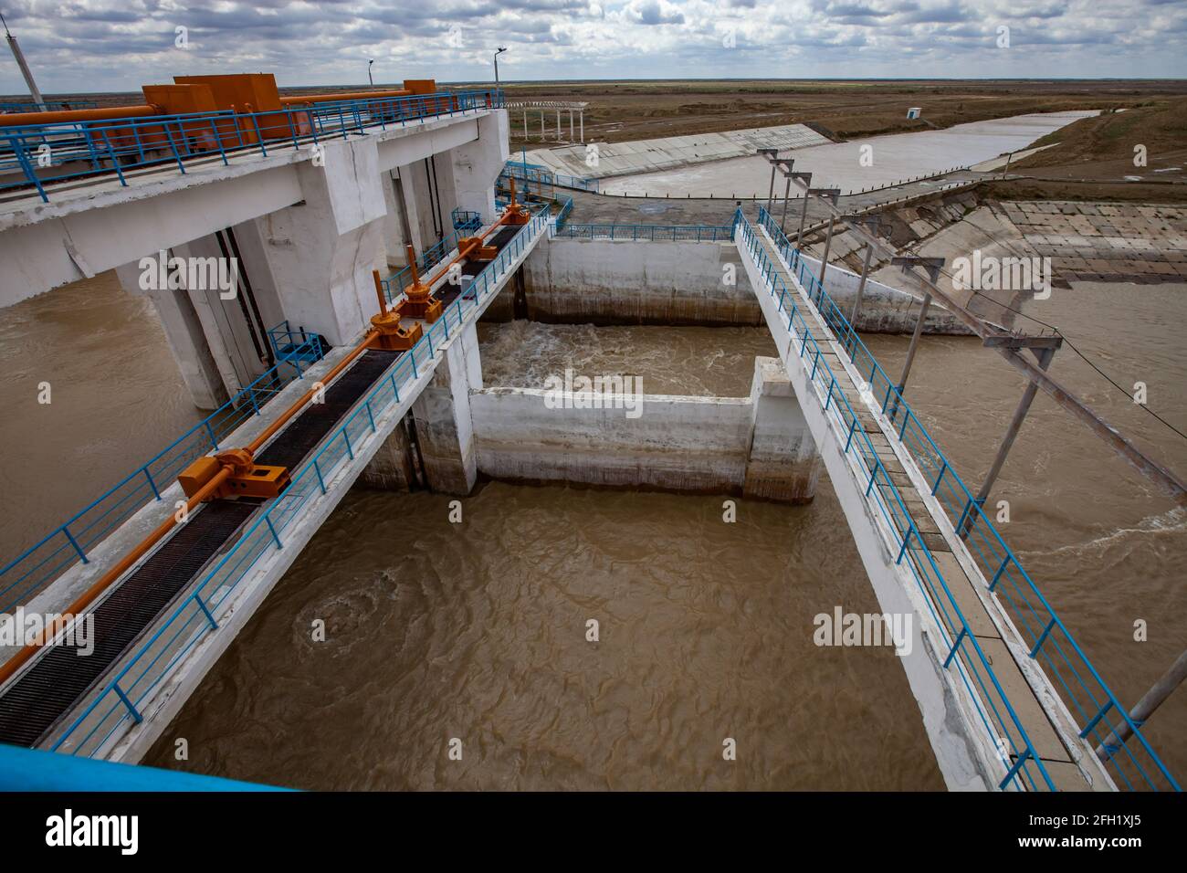 Dam on Shardara river with closing shutters. Aerial view. Kazaly city ...