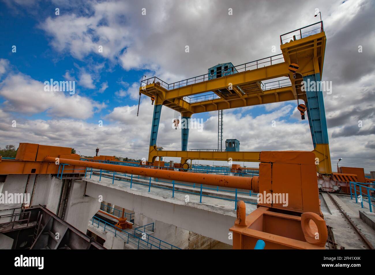 Gentry crane for water shutter lifting on Shardara river dam. blue sky ...