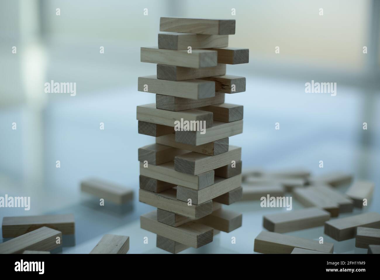 Hand, board game - wooden bars on a glass table Stock Photo - Alamy