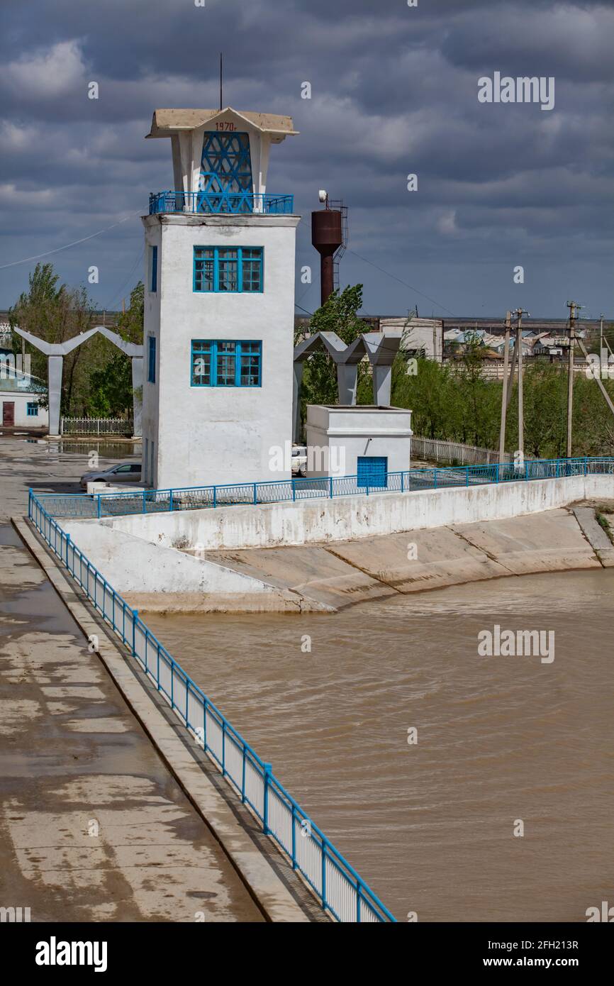 Soviet vintage tower building on Shardara river dam and bridge.Rusted ...