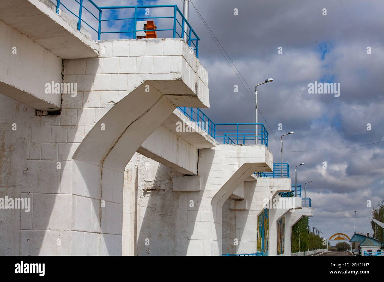 Soviet vintage dam bridge on Shardara river. Close up. Blue sky, clouds ...
