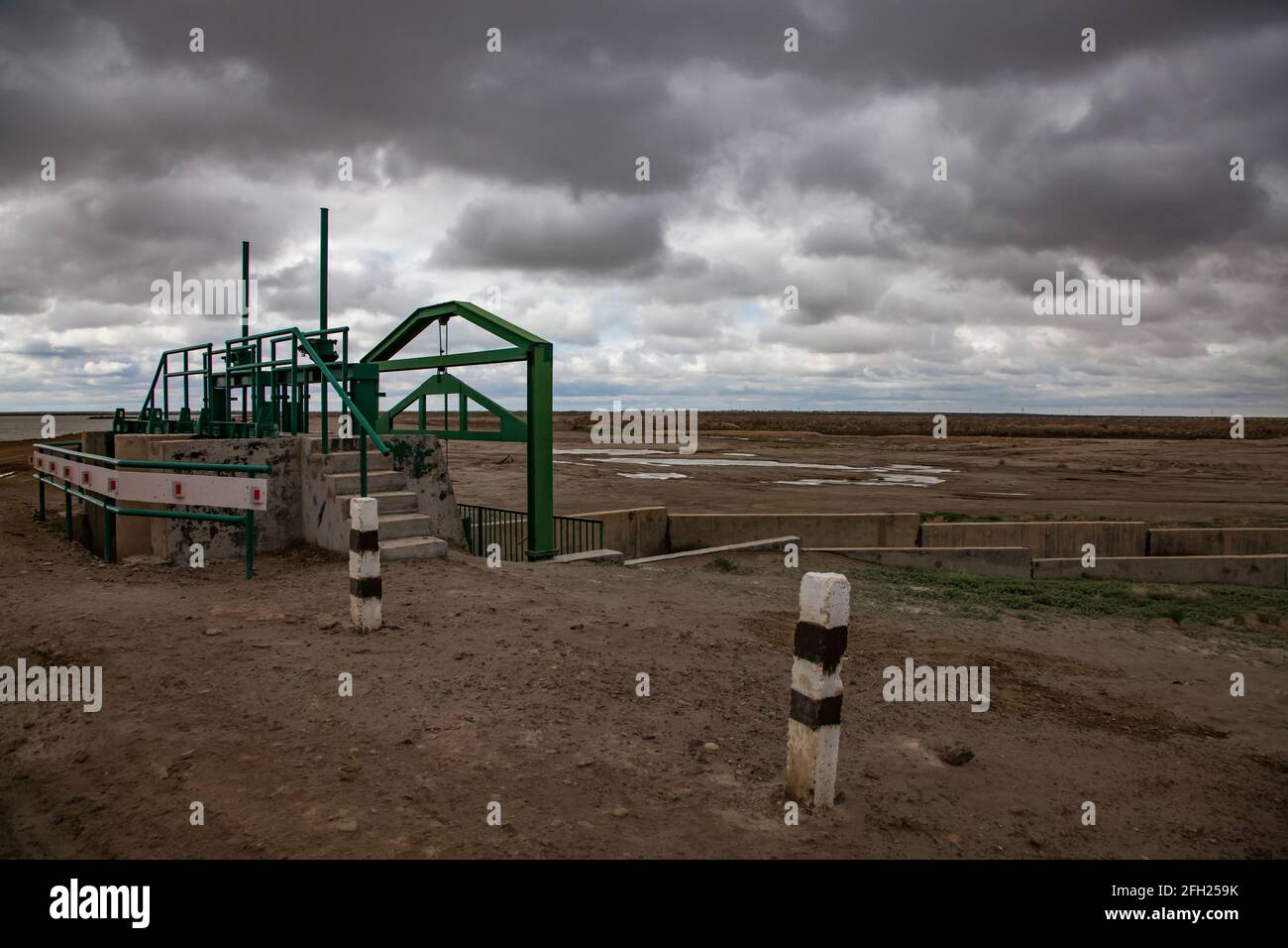 Aklak dam on Shardara river. Small manual water shutter. Dark grey ...