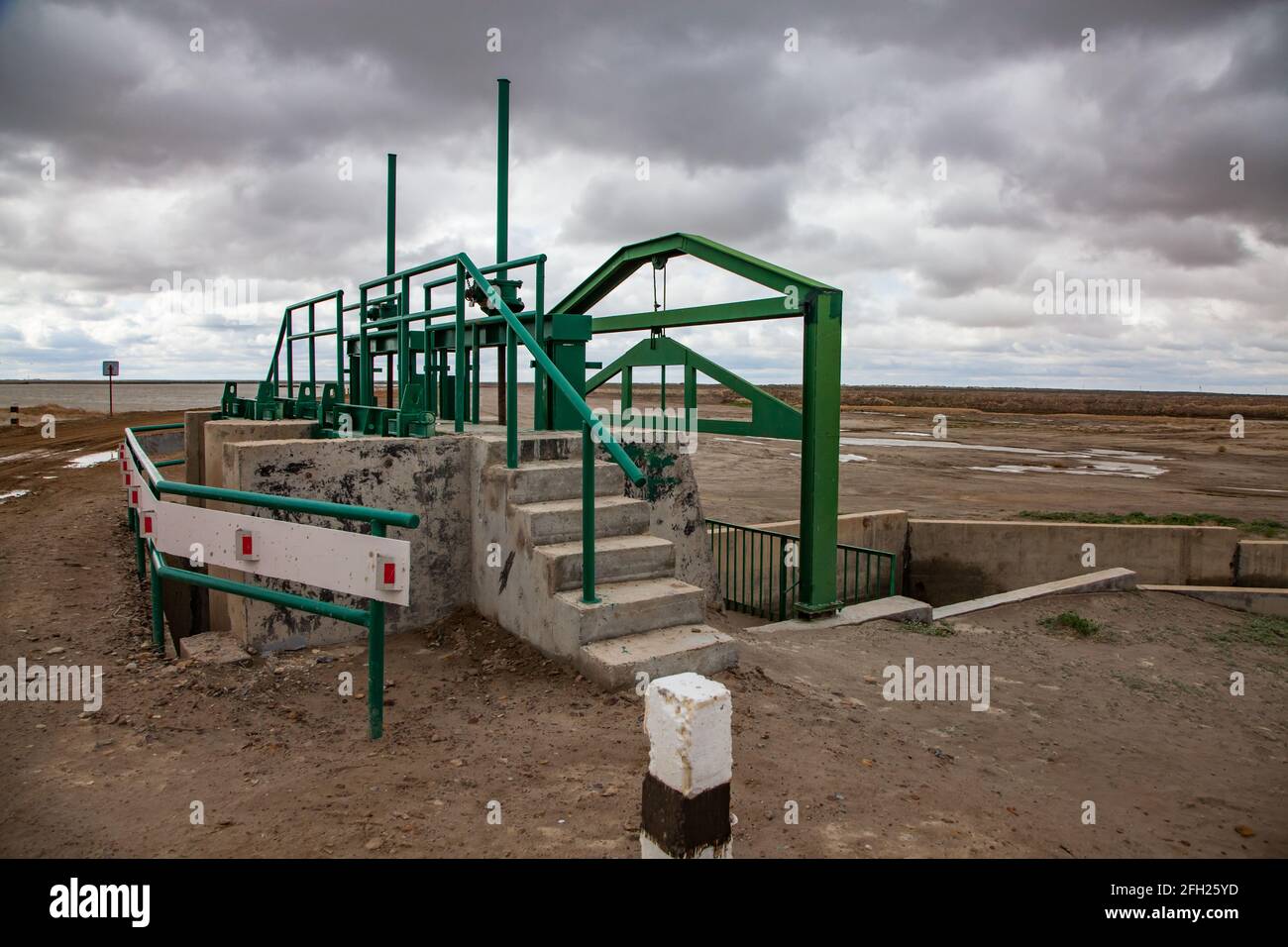 Aklak dam on Shardara river.Small manual water shutter. Grey cloudy sky ...