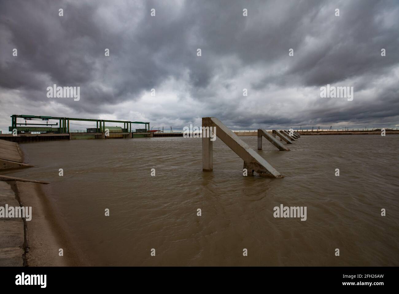 Aklak dam on Shardara river. Concrete breakwaters in channel. Water ...