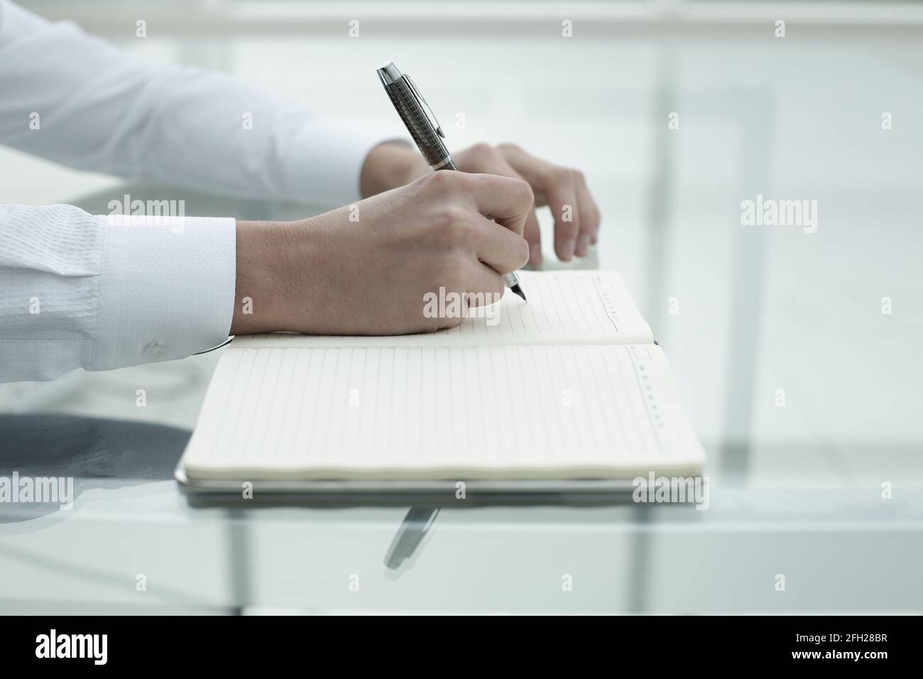 Office worker's hand writes in notebook. Highly professional manager ...