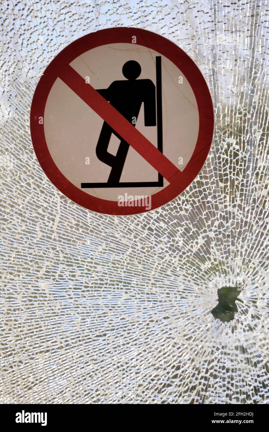 Broken window and warning sign in the train Stock Photo - Alamy