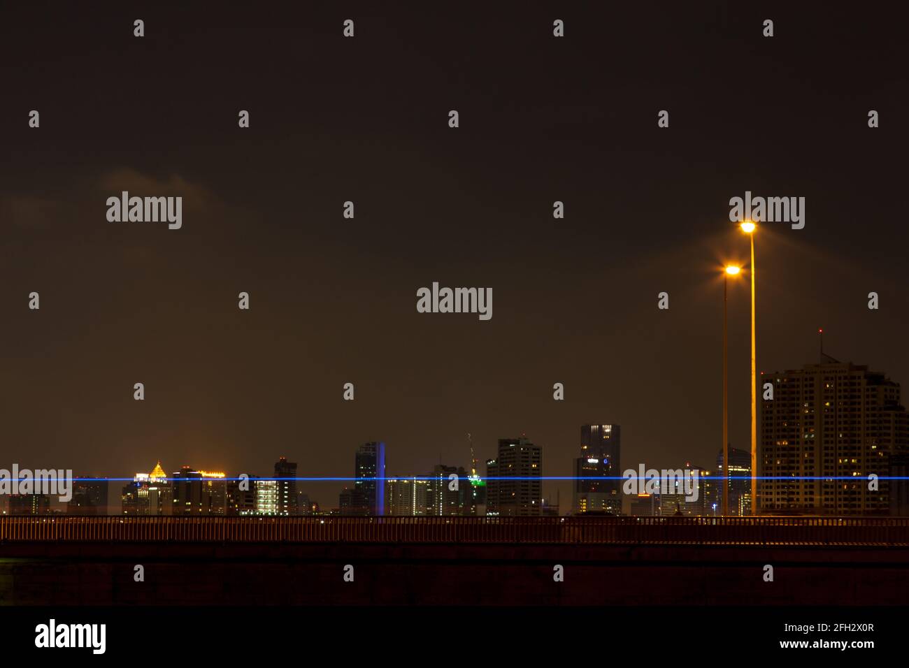 Bridge at night. The light poles and lights of cars on the bridge ...