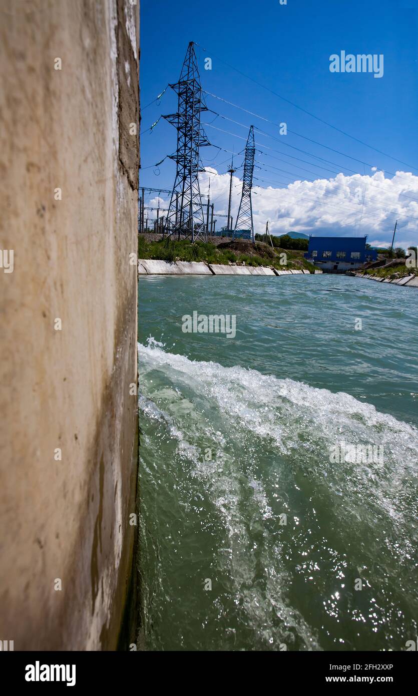Hydroelectric power plant. Turbulent water before dam. Concrete dam ...