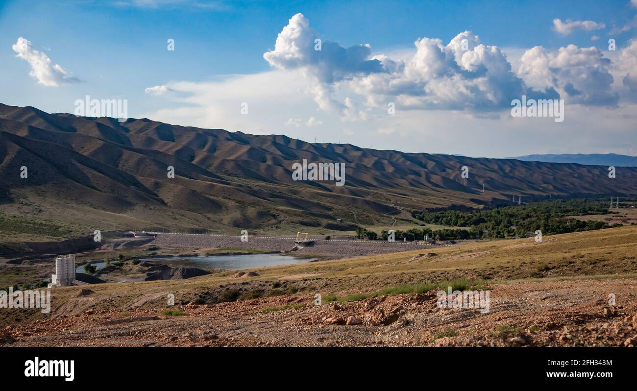 Scenic view of second dam on Sharyn river. Asphalt road and bridge ...