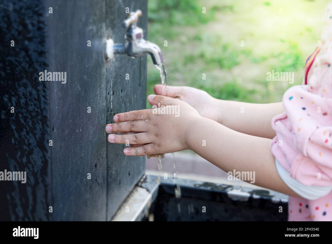 A child washing his hands by the tap Stock Photo - Alamy