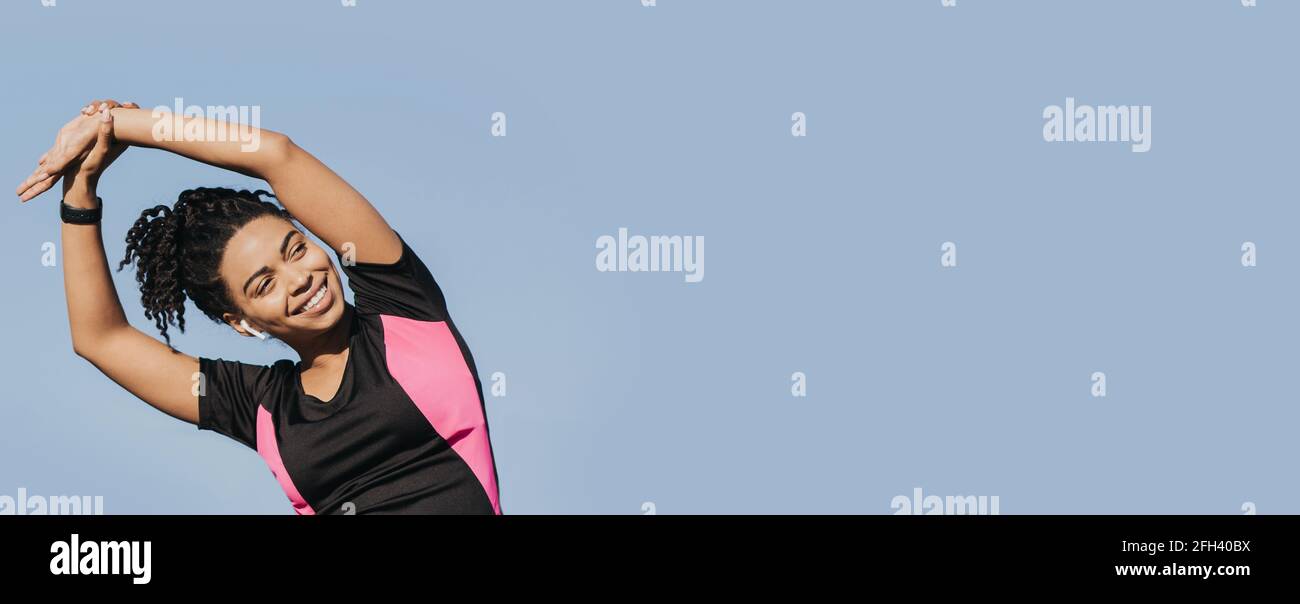 Fitness model in fashion sportswear doing pilates exercise in city ...