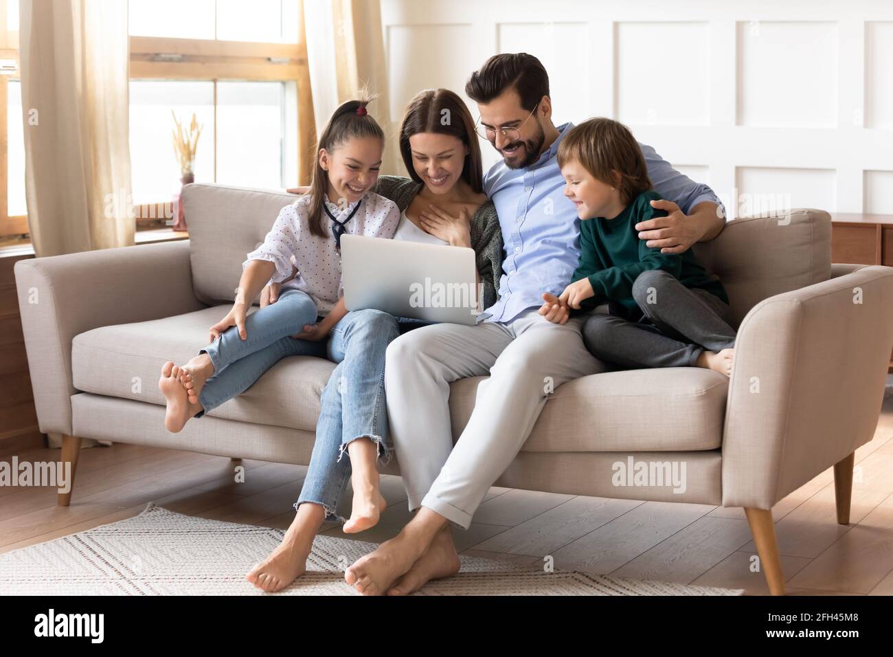 Happy family with children use laptop at home Stock Photo - Alamy