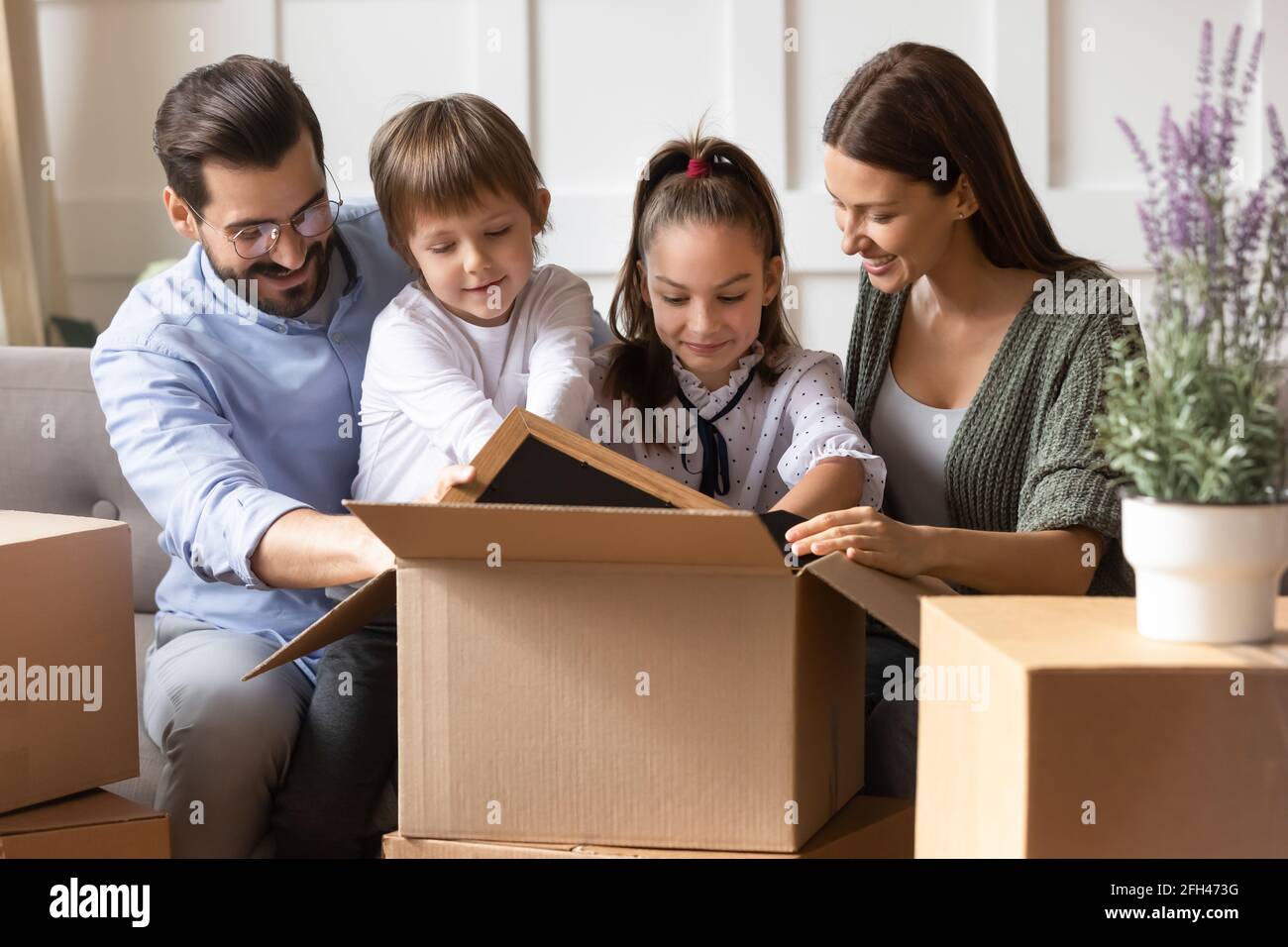 Happy family with kids unpack on relocation day Stock Photo - Alamy