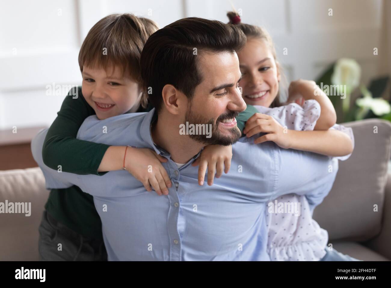Happy father play with excited little kids Stock Photo - Alamy