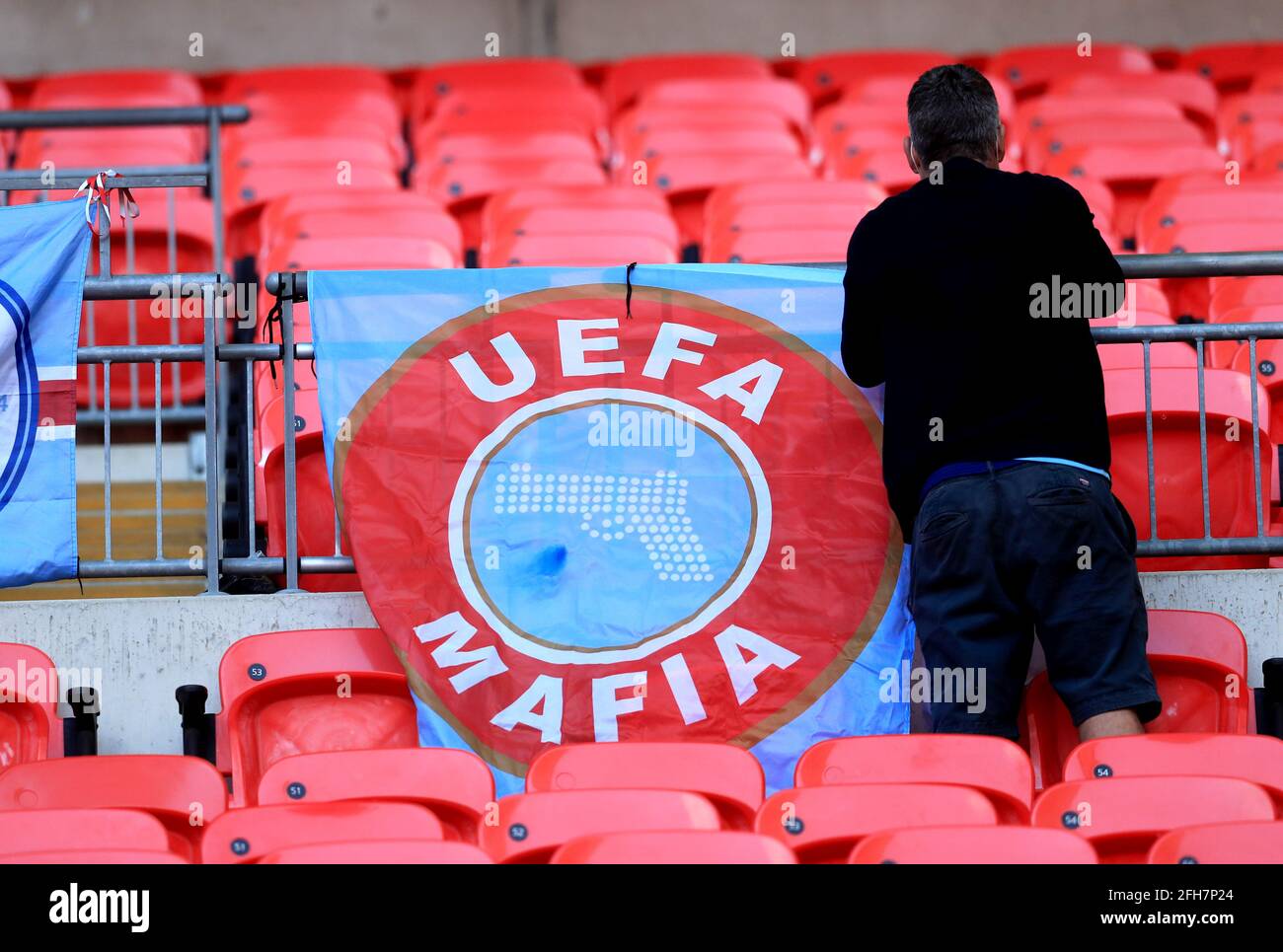 A fan ties a UEFA Mafia banner to the stands ahead of the Carabao Cup ...