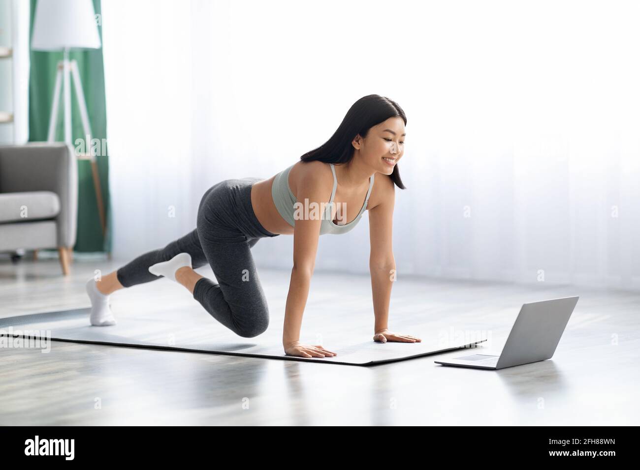 Fitness Online. Happy Young Asian Woman Doing Sports At Home With ...