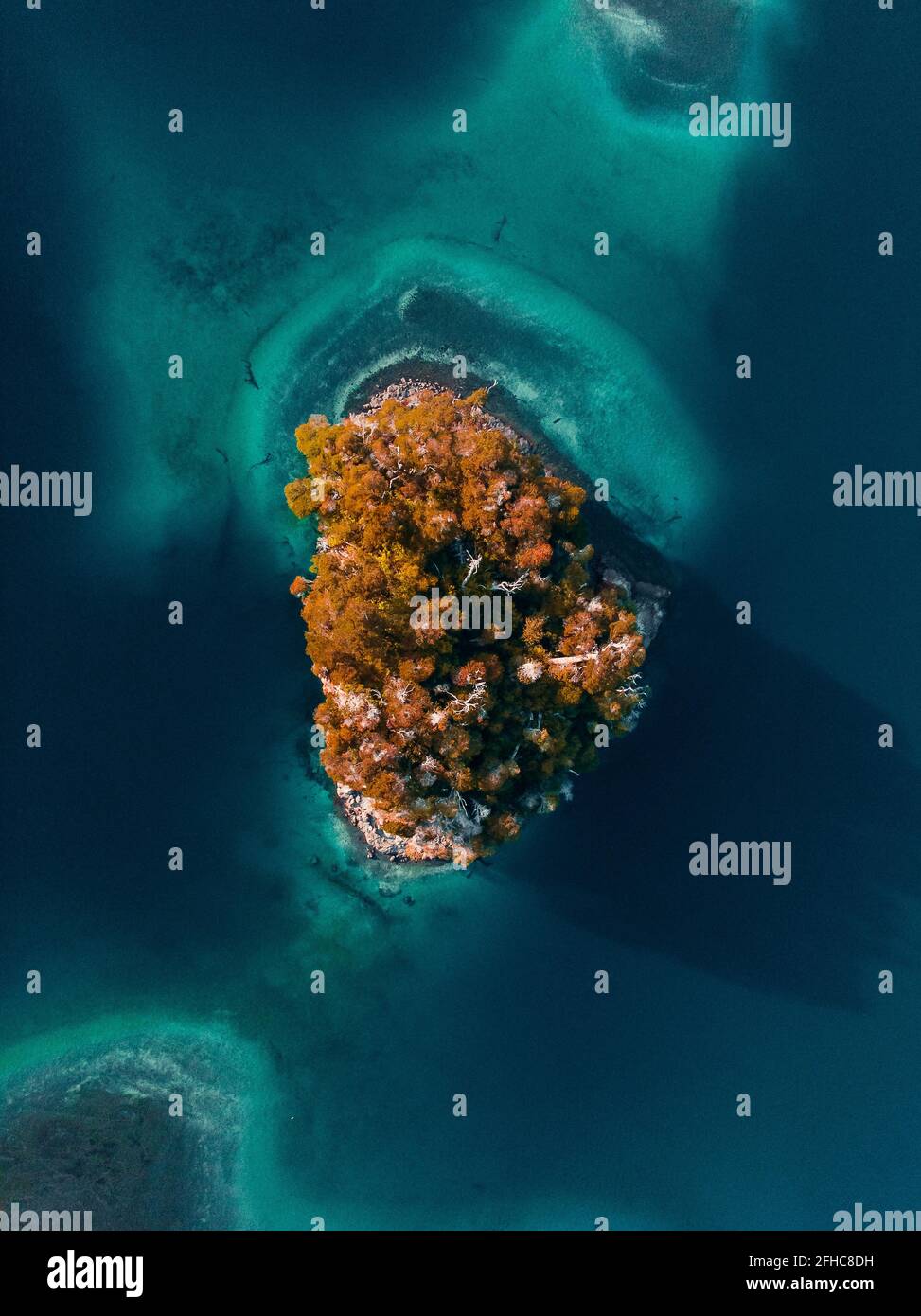 From above breathtaking aerial view of island in calm lake with ...