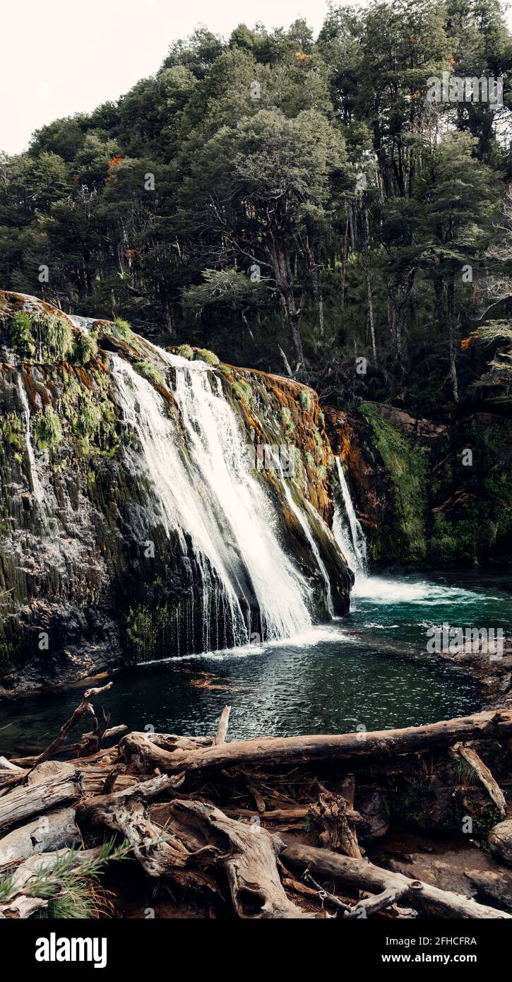 Spectacular view of powerful stream of waterfall flowing in lake in ...