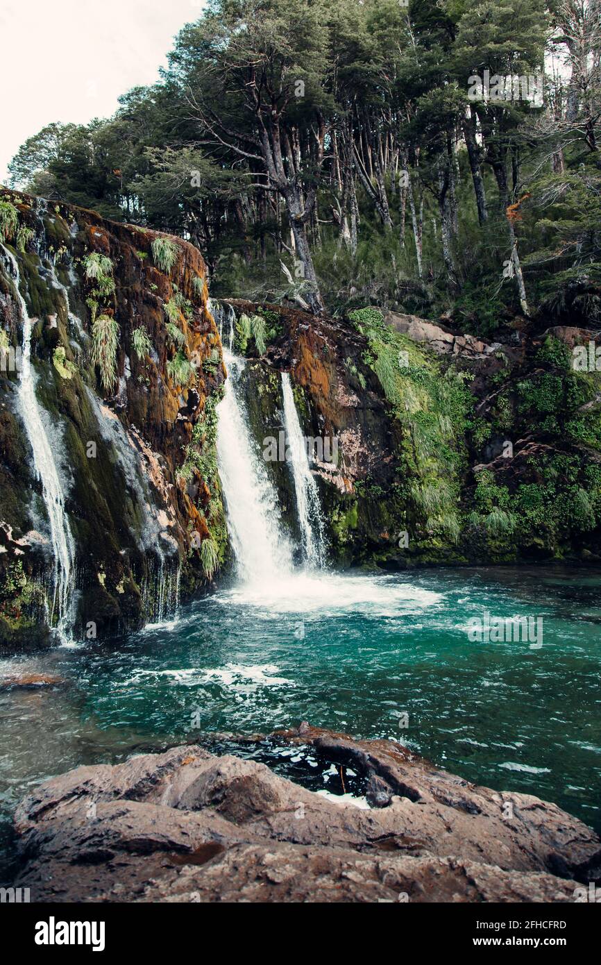 Spectacular view of powerful stream of waterfall flowing in lake in ...