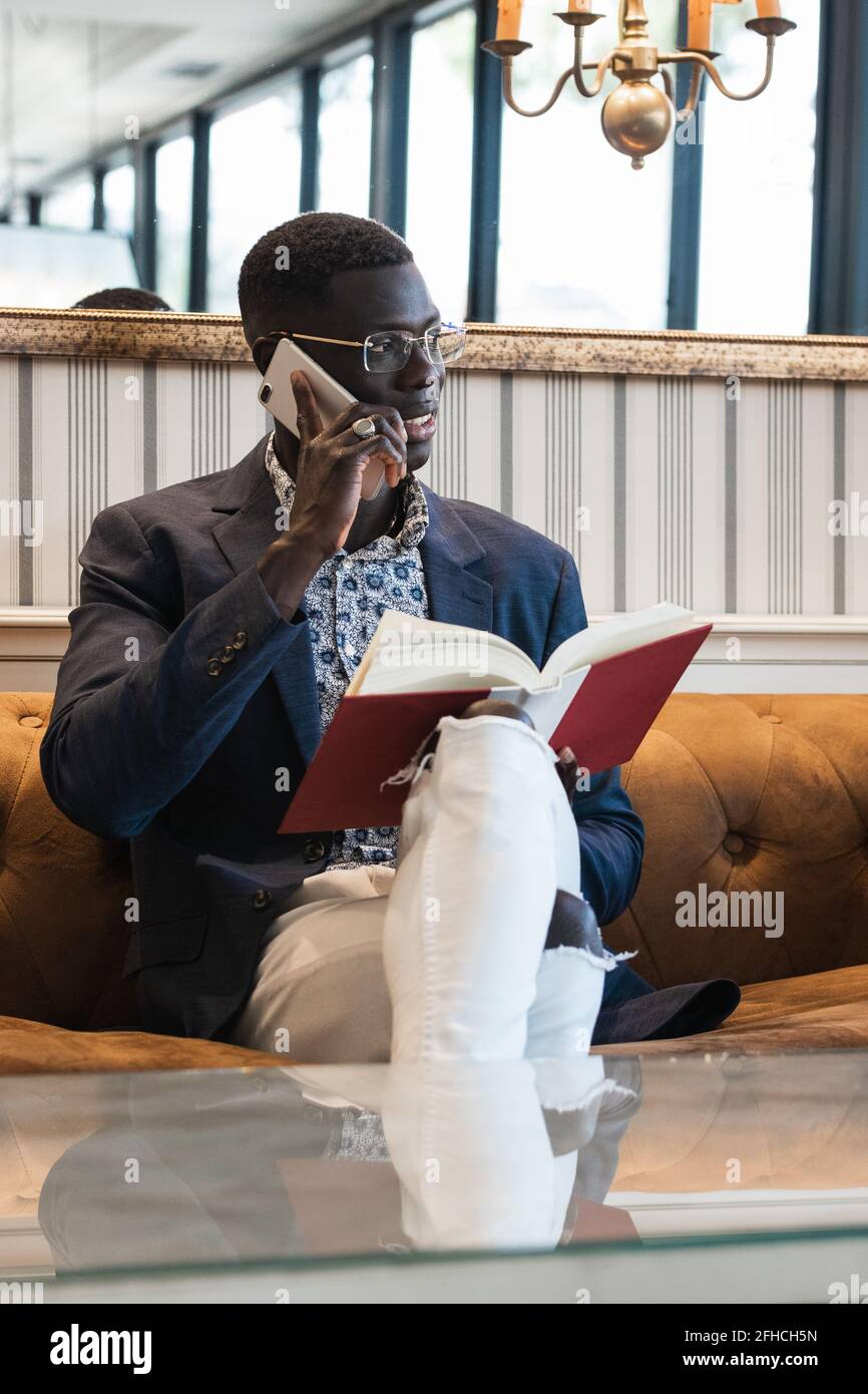 Legs crossed business man, sofa hi-res stock photography and images - Alamy