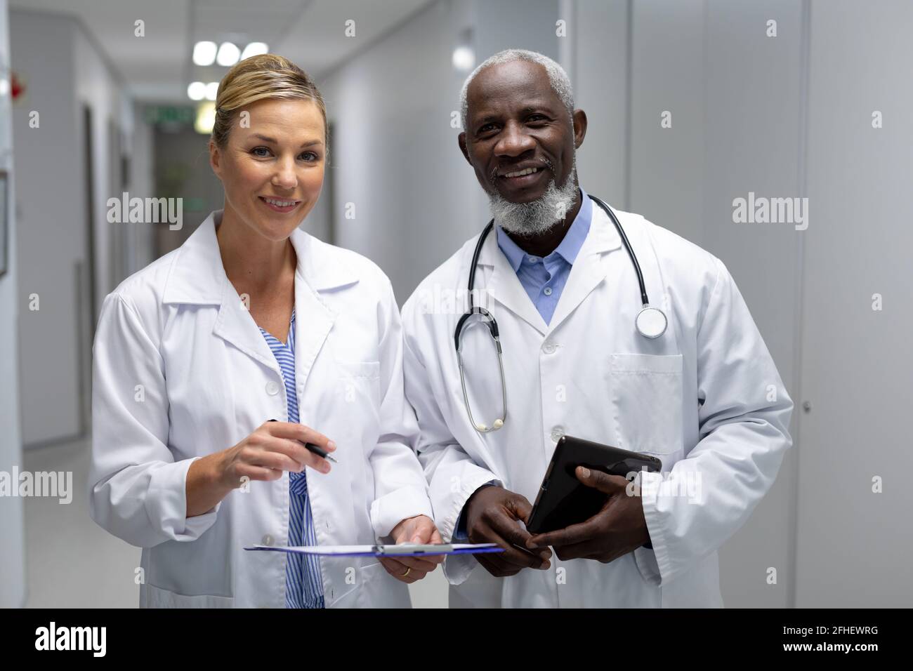 Portrait of diverse male and female doctors standing in hospital ...