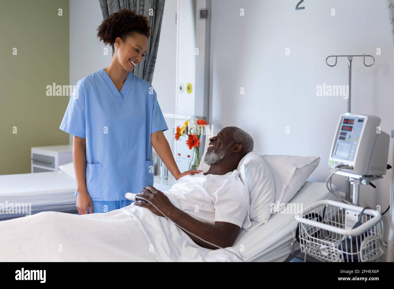Mixed race female doctor and african american male smiling to each ...