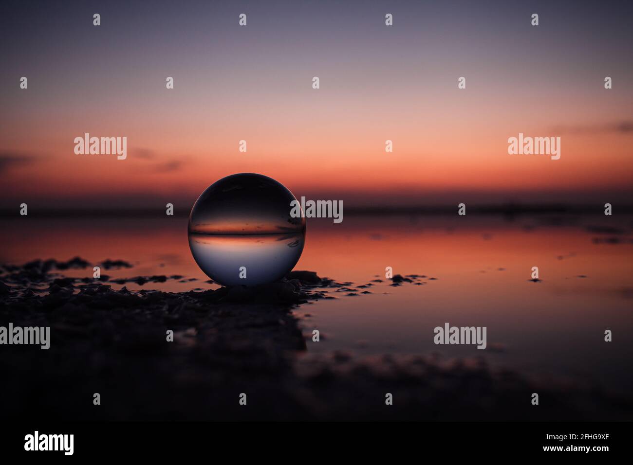 glass optical ball on the sandy azure coast of the sea Stock Photo - Alamy