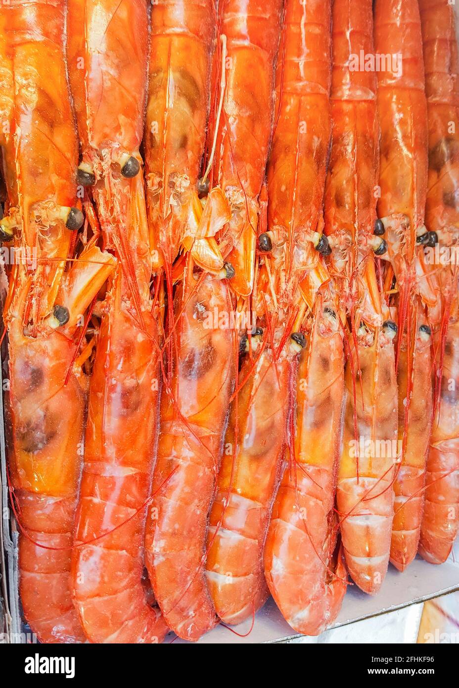 Frozen King prawns, red prawns close-up, seafood consumption concept ...