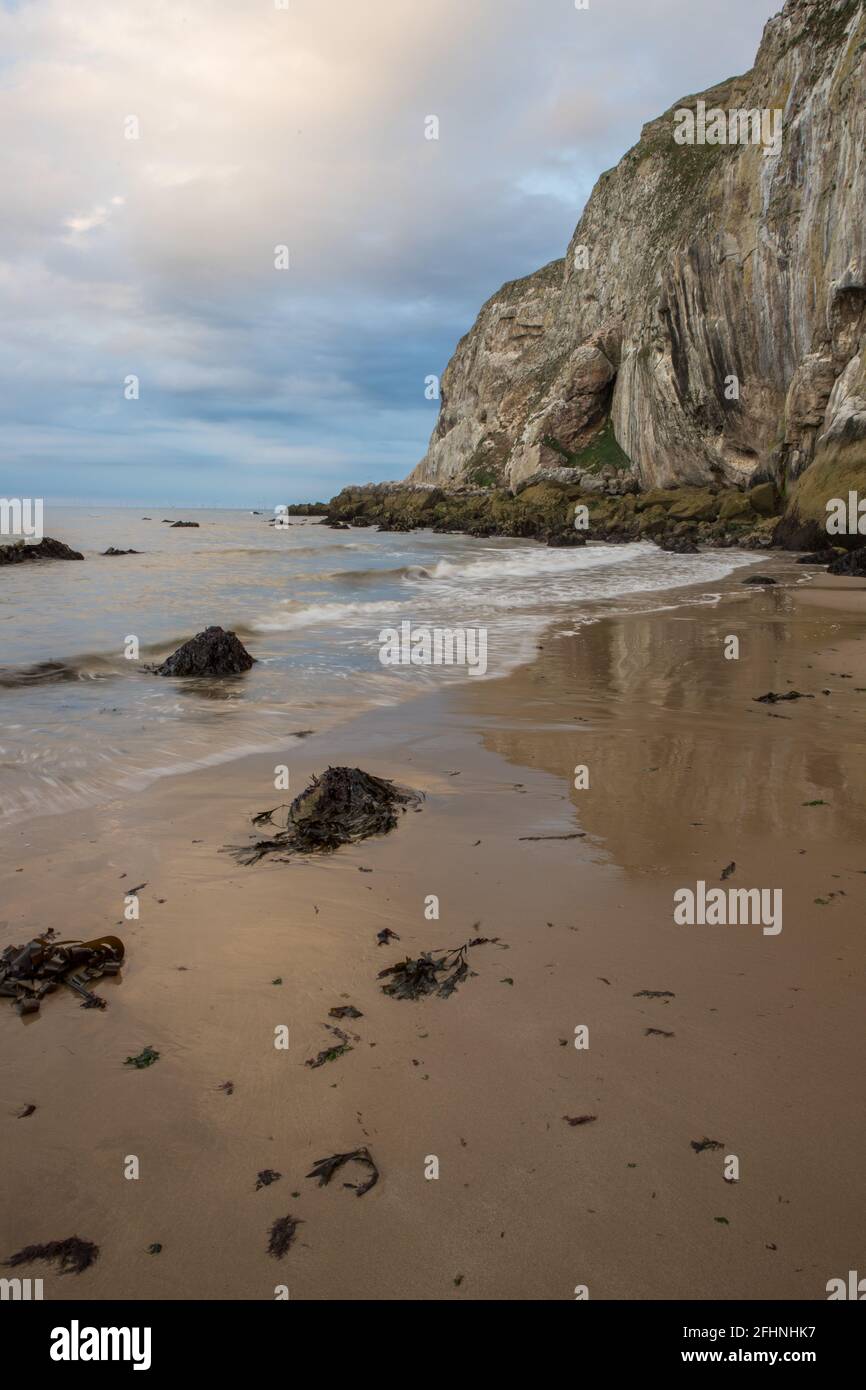Wave splashing on the rocks at the base of the little Orme, Llandudno ...