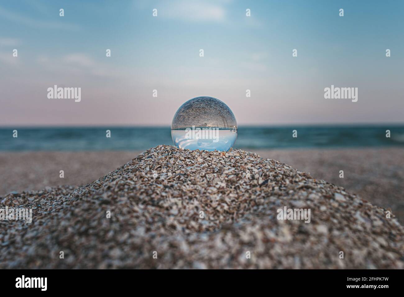 glass optical ball on the sandy azure coast of the sea Stock Photo - Alamy
