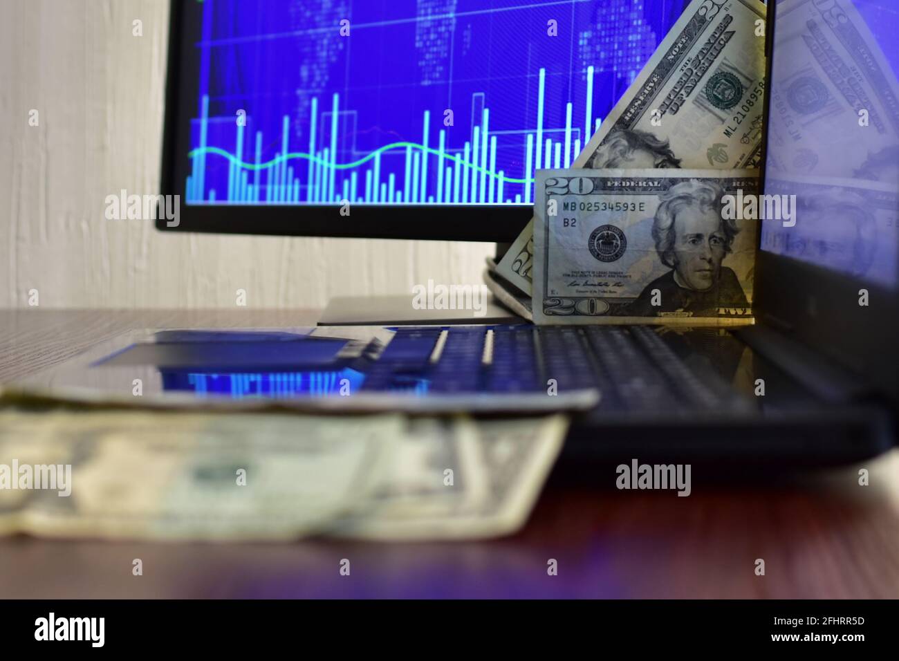 Dollar banknotes on blurred background of computer screen and monitor ...